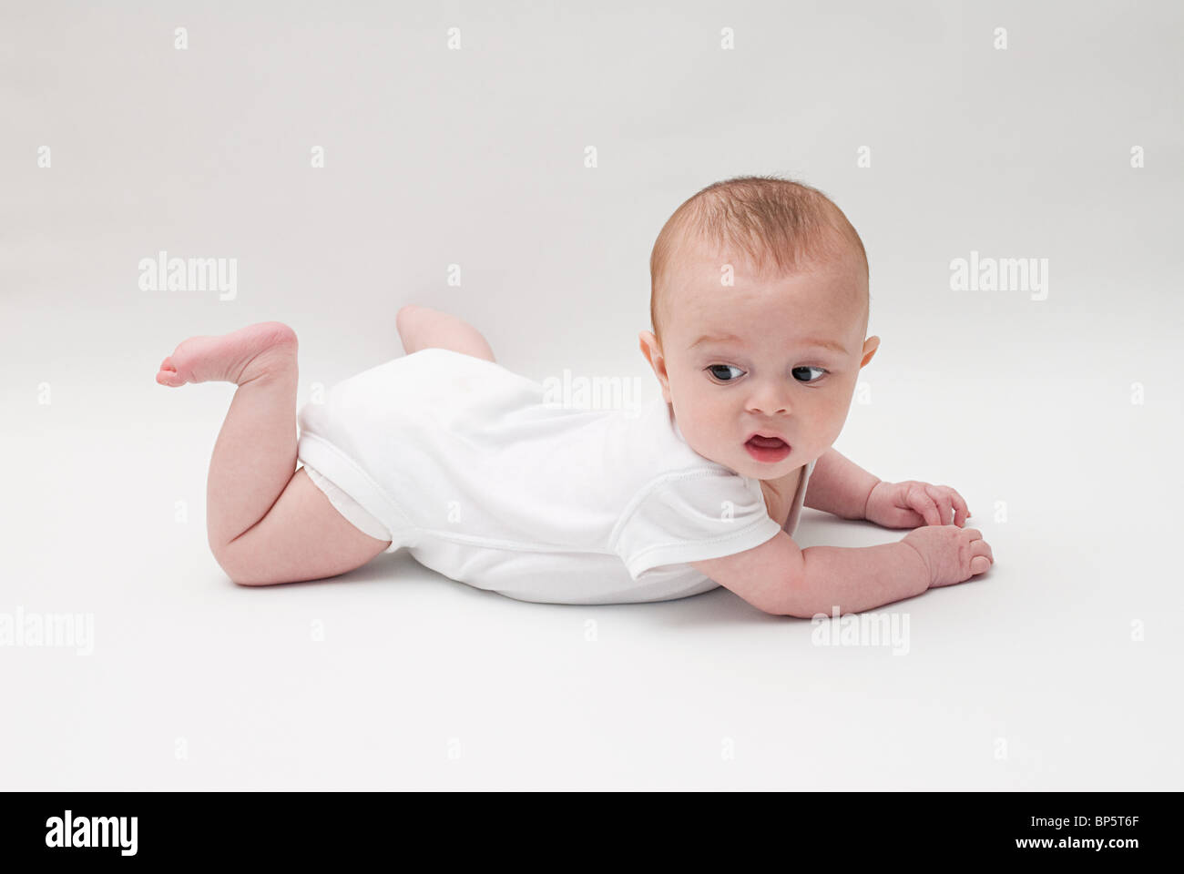 Portrait of a baby boy lying on his front Stock Photo - Alamy