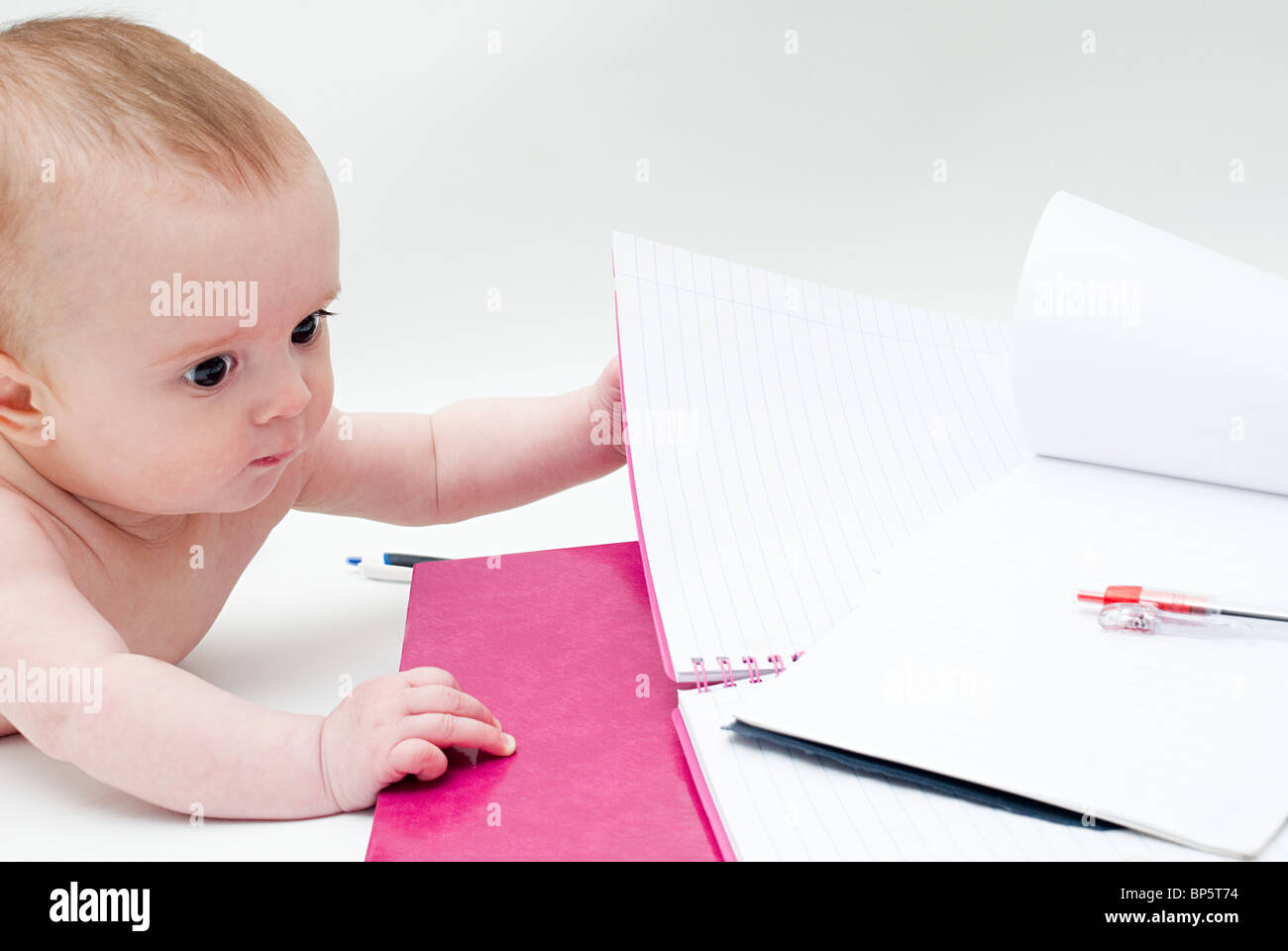 Baby with notebooks Stock Photo - Alamy