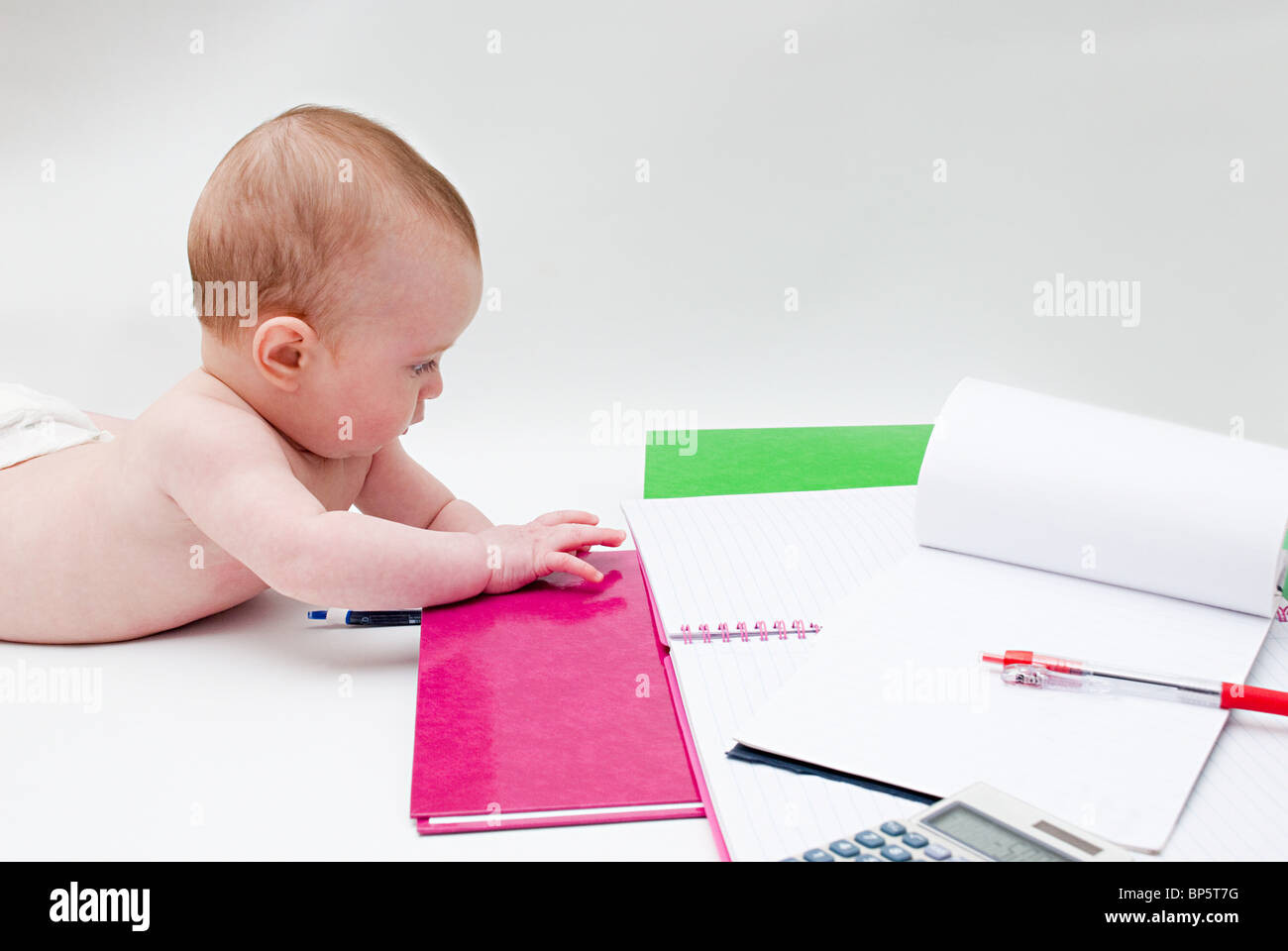 Baby with notebooks Stock Photo - Alamy