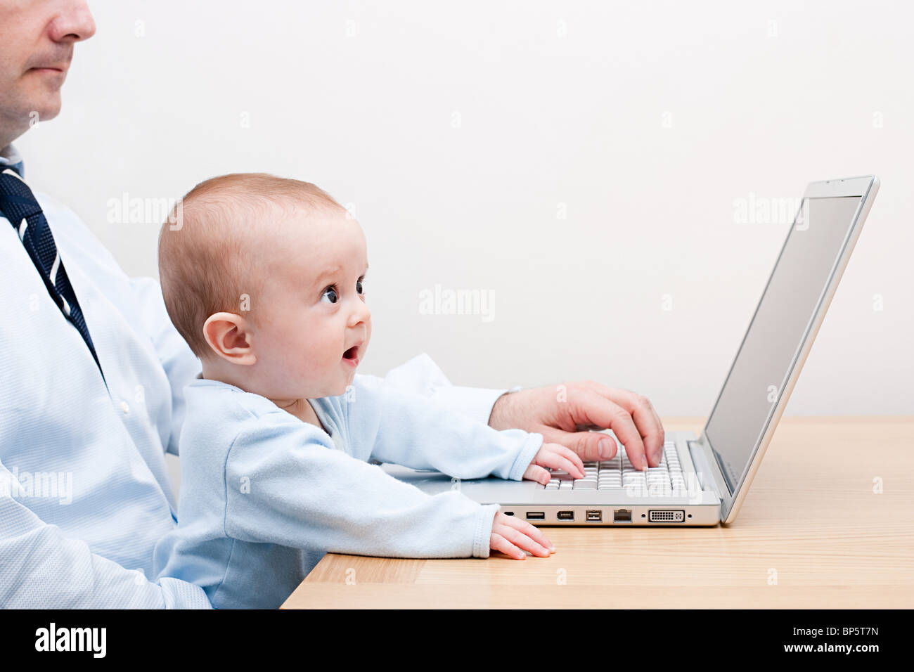 Working father and baby at laptop Stock Photo - Alamy