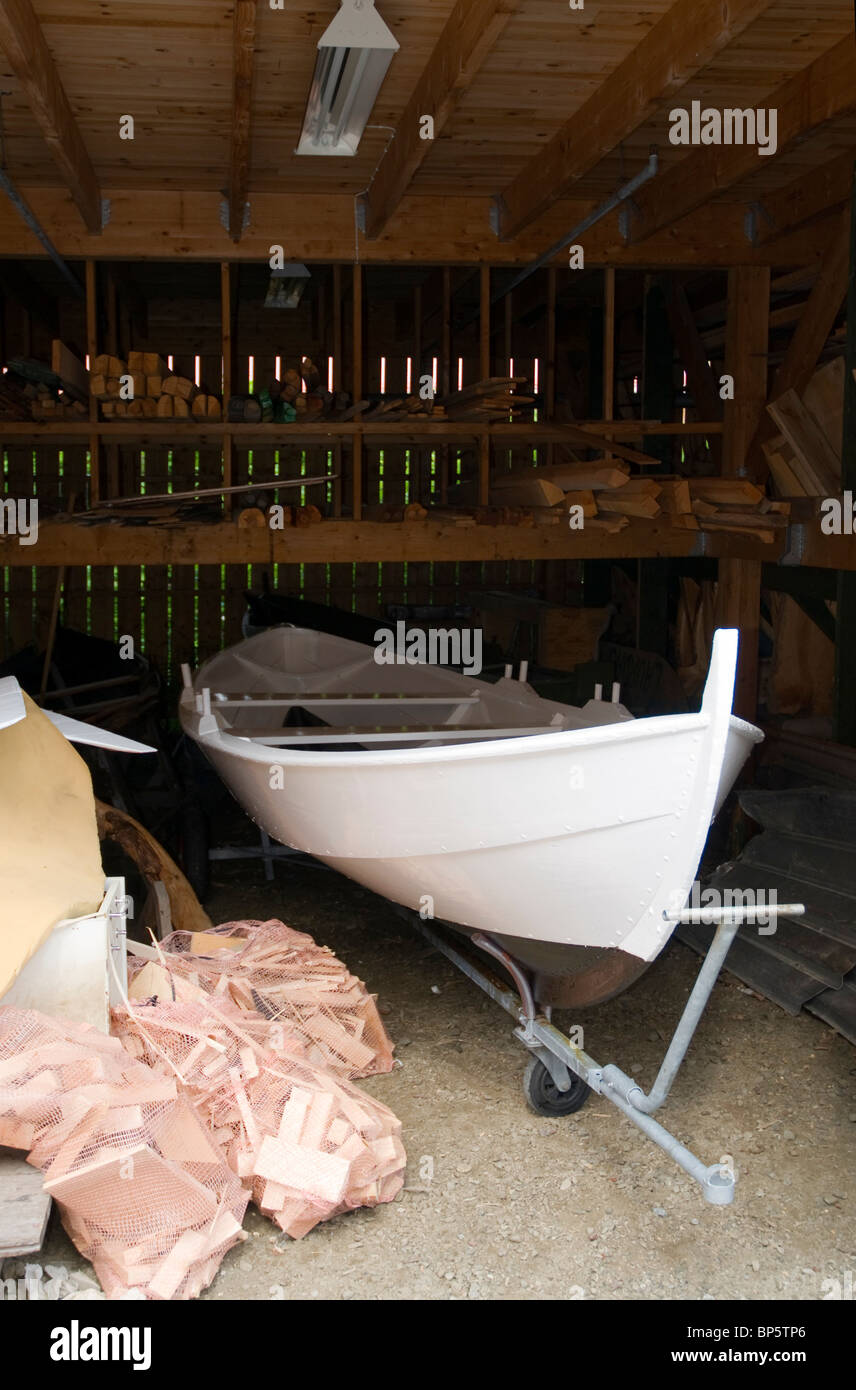 Traditionally built Norwegian wooden rowing boat, painted white. Inside ...