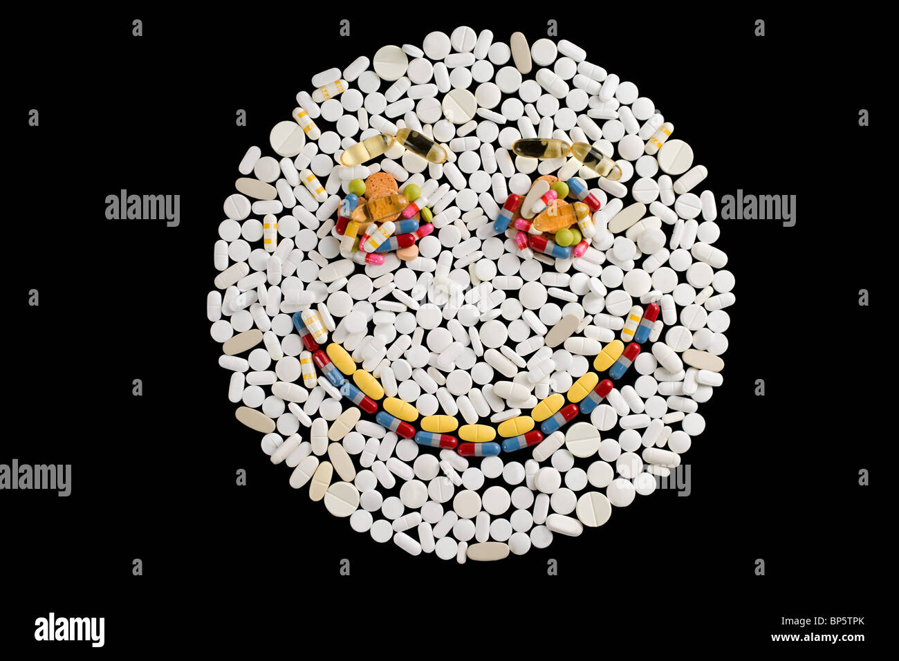 Happy face made from pills Stock Photo - Alamy