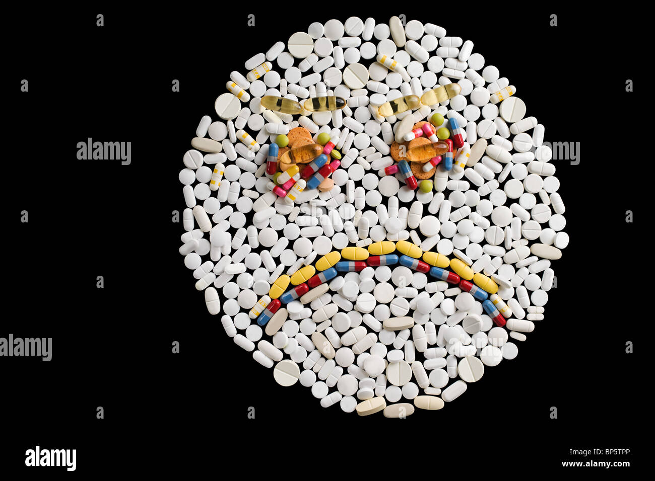 Sad face made from pills Stock Photo - Alamy