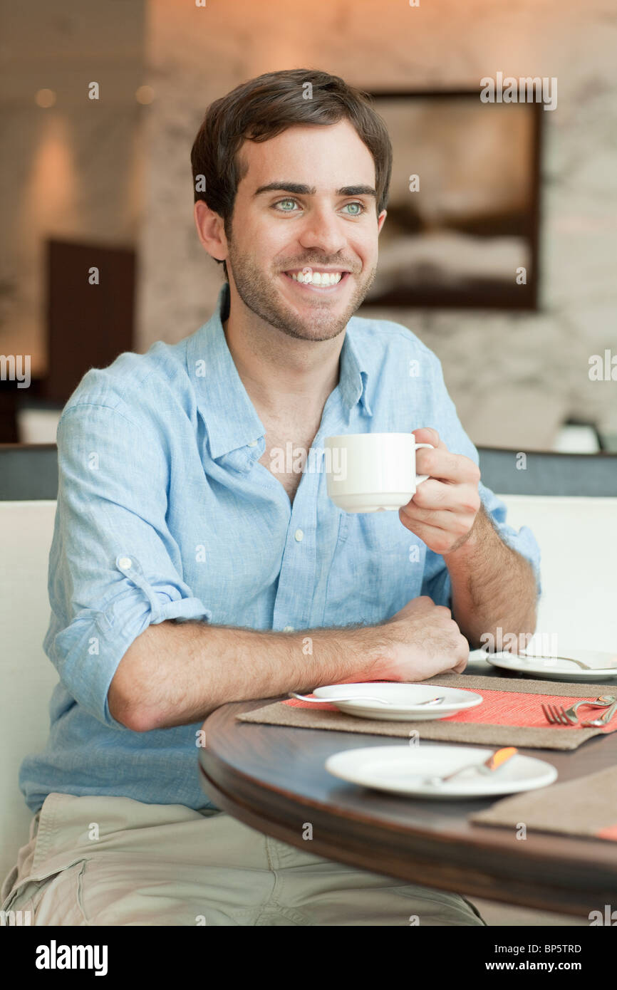 Young man with coffee Stock Photo - Alamy