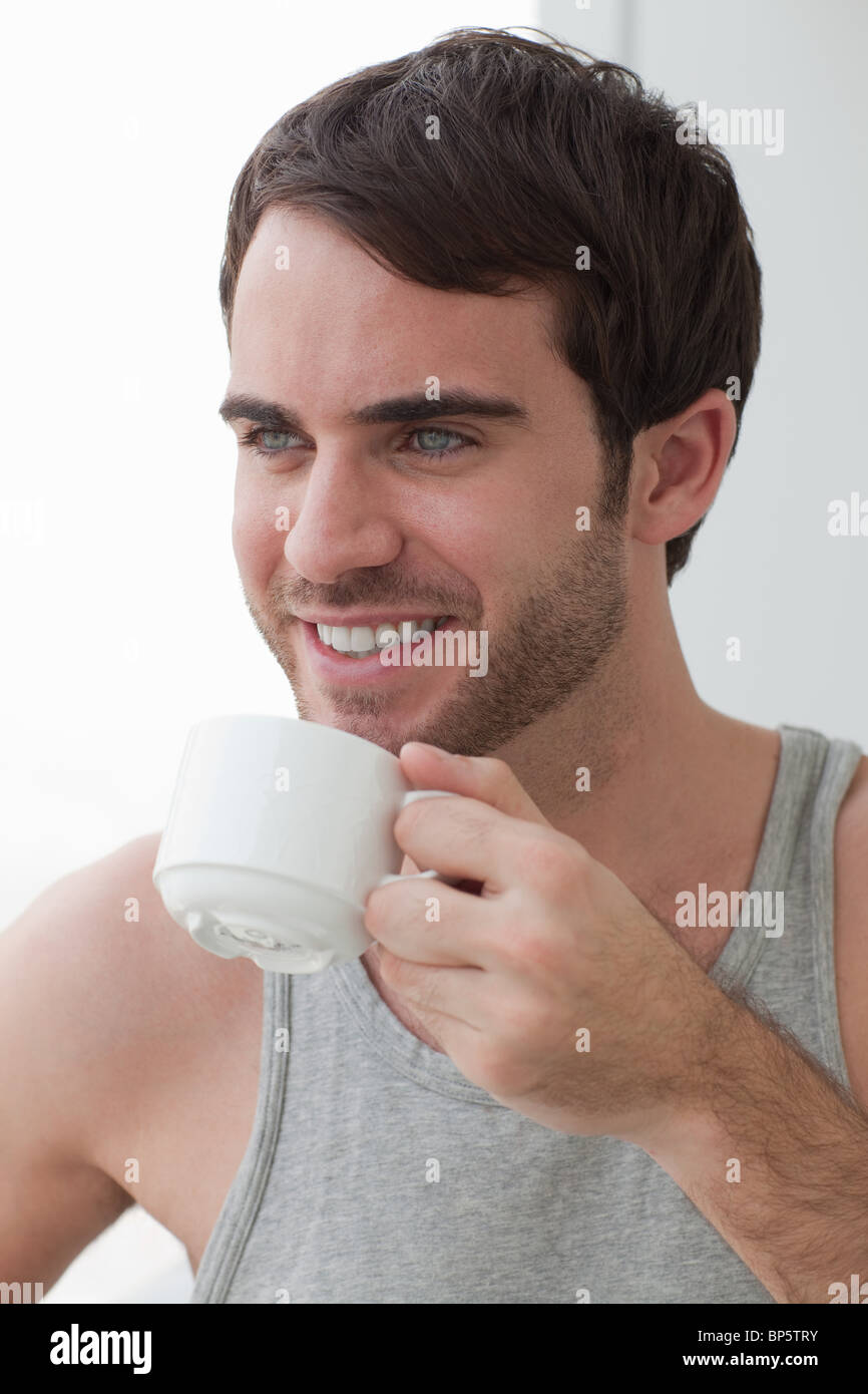 Young man with coffee Stock Photo - Alamy