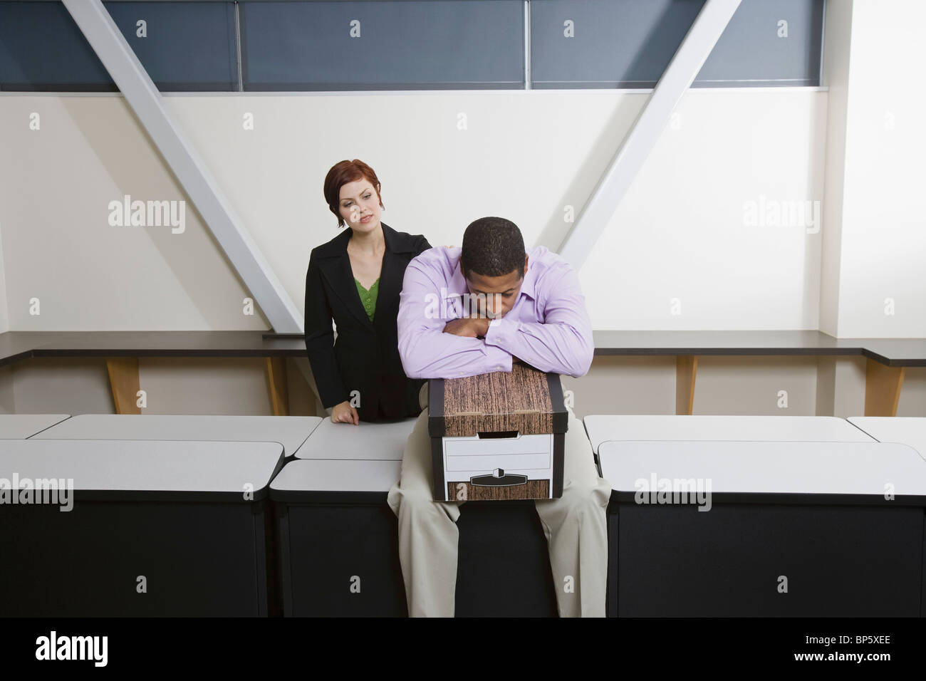 Depressed Man Sitting on Desk with Moving Box Stock Photo - Alamy