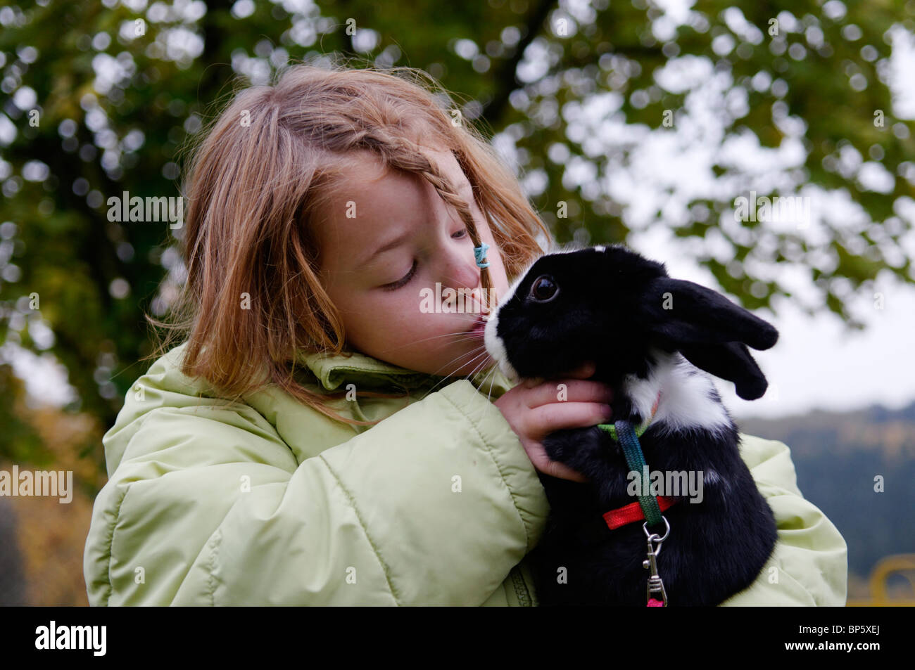 young girl kissing her pet rabbit Stock Photo - Alamy