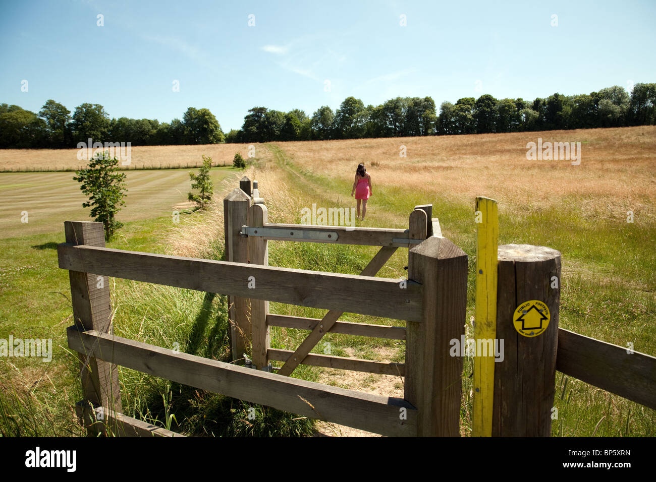 A young woman walking in the british countryside, Lyminge village near ...