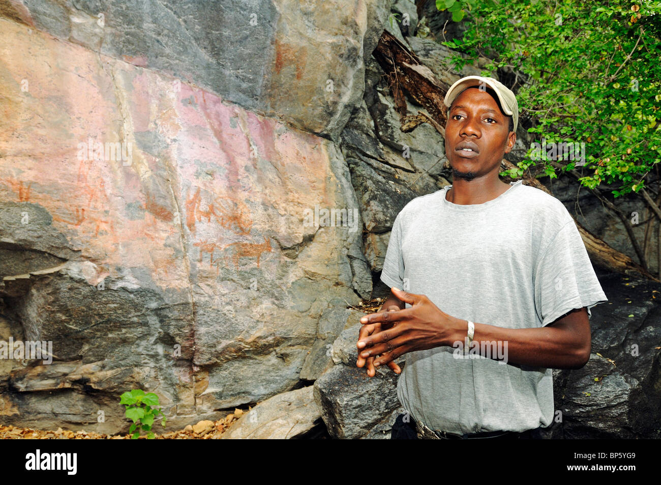 Guide showing the petroglyphs at Tsodilo Hills, UNESCO world heritage ...