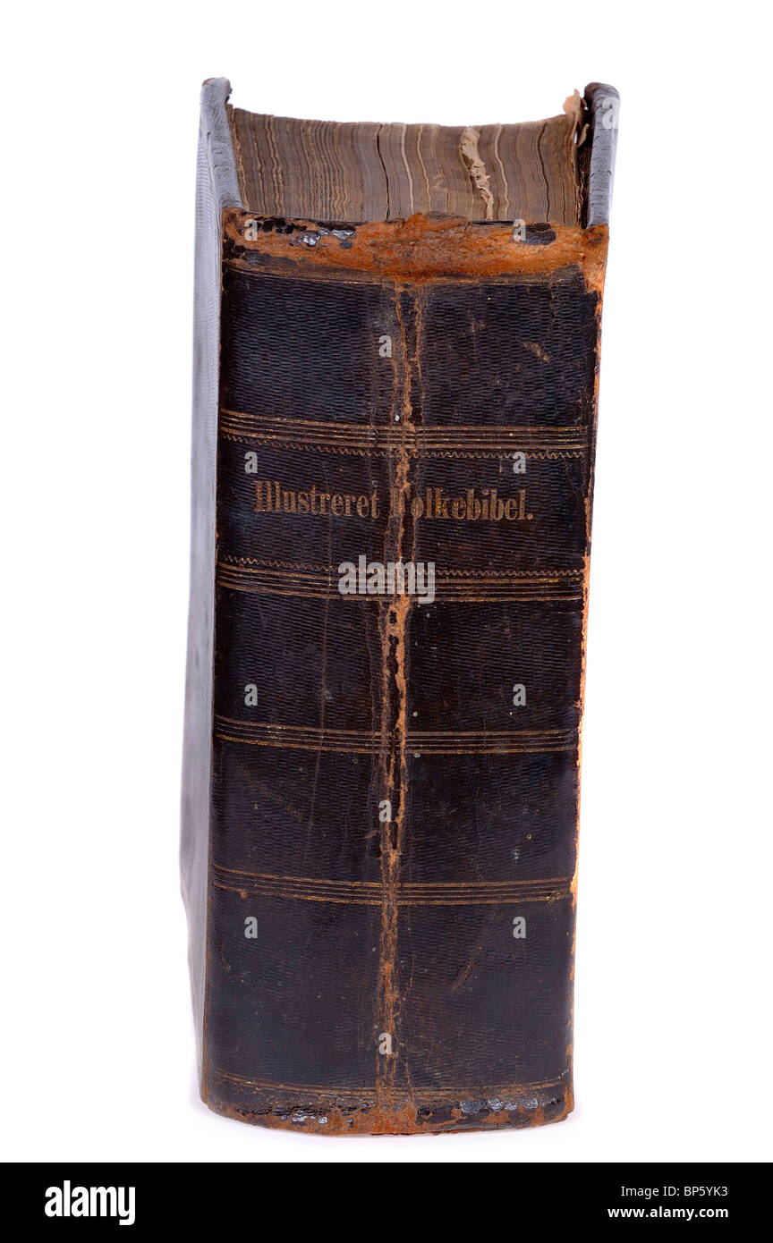 Old bible, over 100 years old, taken on clean white background. On the ...