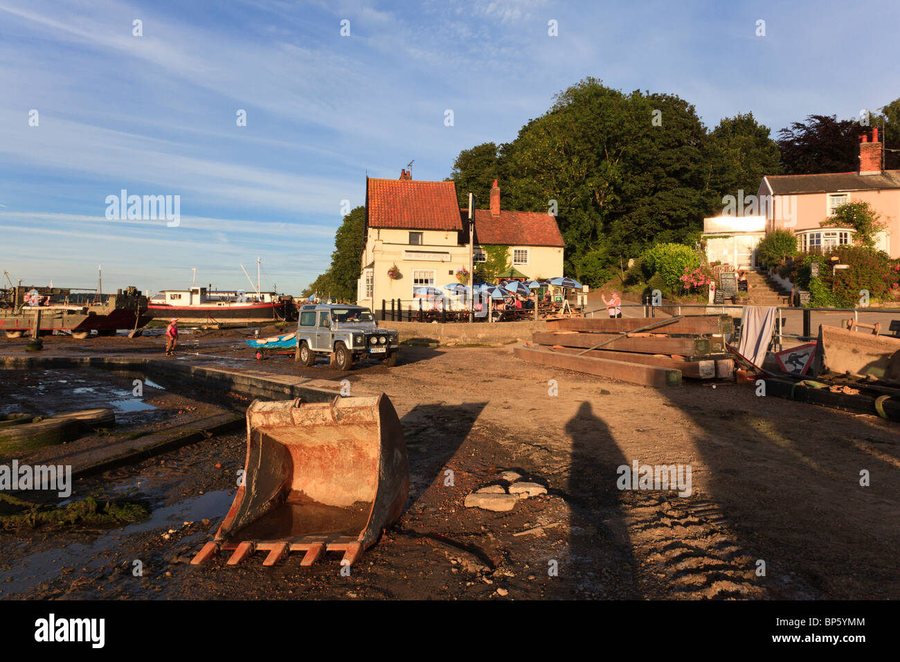Shadow of photographer at Pin Mill at sunset, bathed in a warm light ...