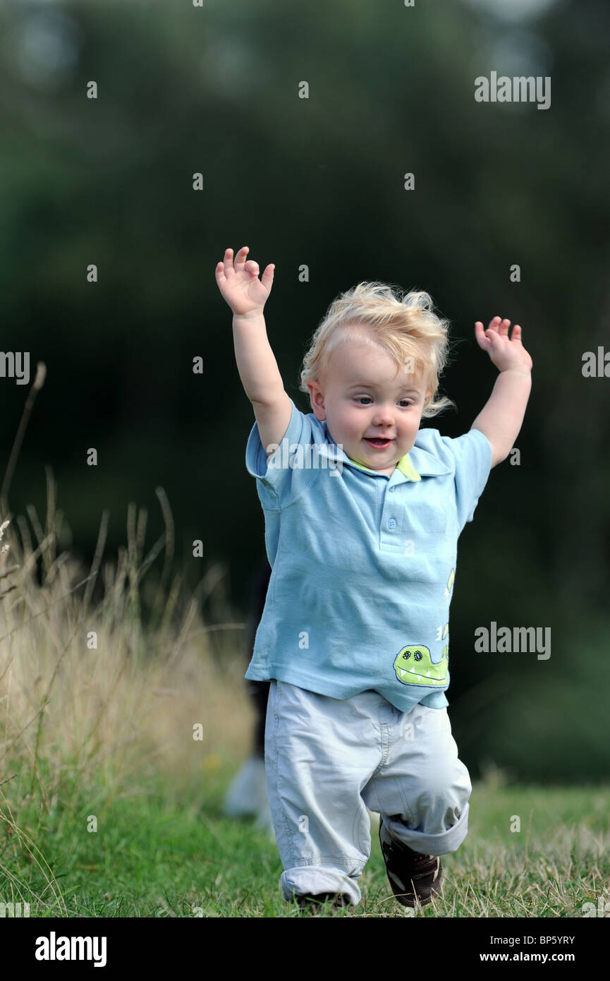 One year old baby boy learning to walk Stock Photo - Alamy