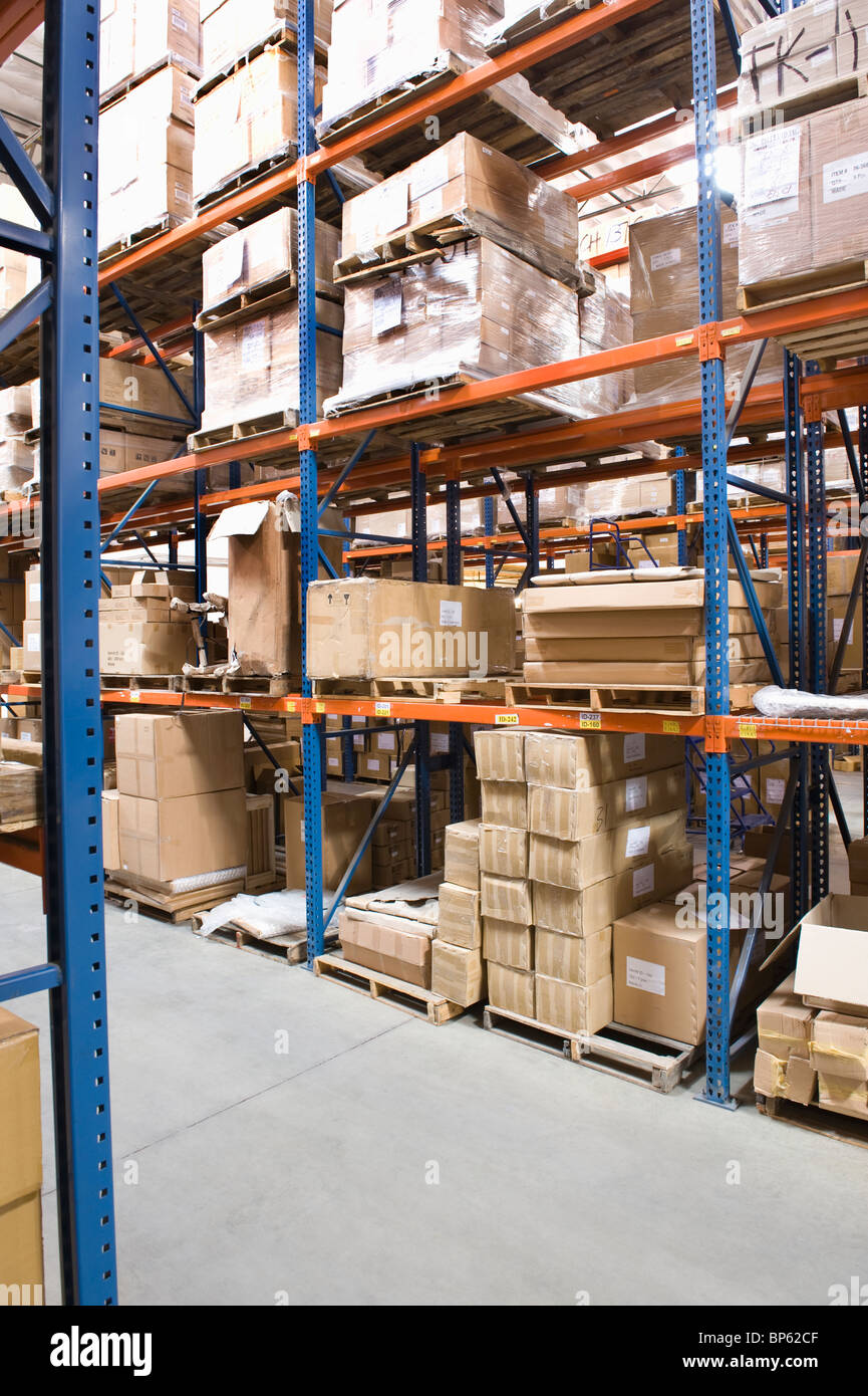 Cardboard boxes on shelves in distribution warehouse Stock Photo - Alamy