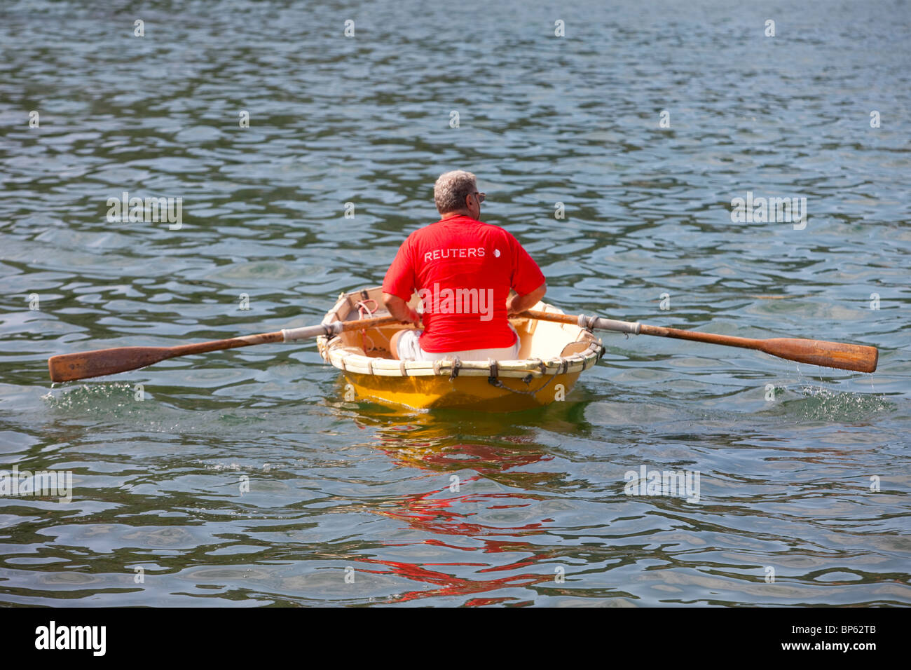 Man Rowing a boat Stock Photo - Alamy