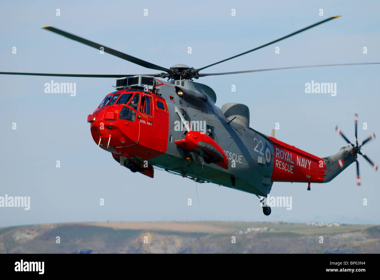 Royal Navy search & rescue helicopter flying over sea Stock Photo - Alamy