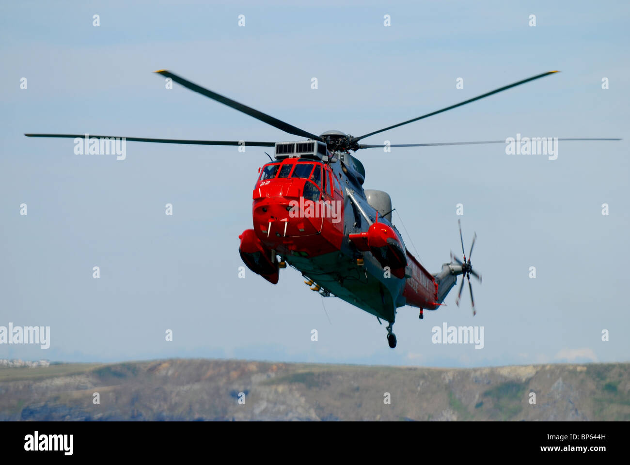 Royal Navy rescue helicopter flying over sea Stock Photo - Alamy