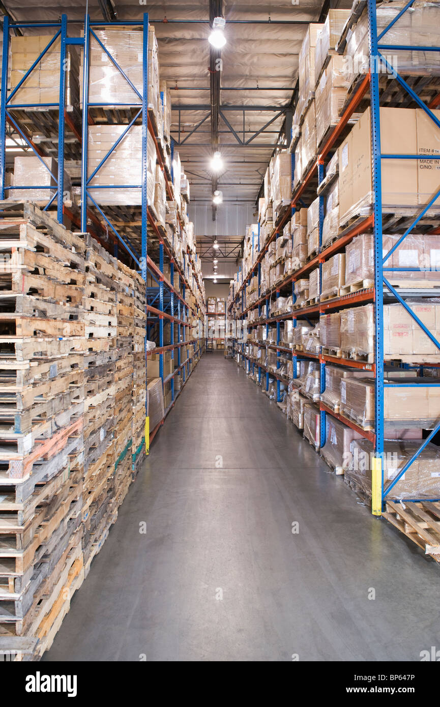 Wooden pallets and cardboard boxes in distribution warehouse Stock ...