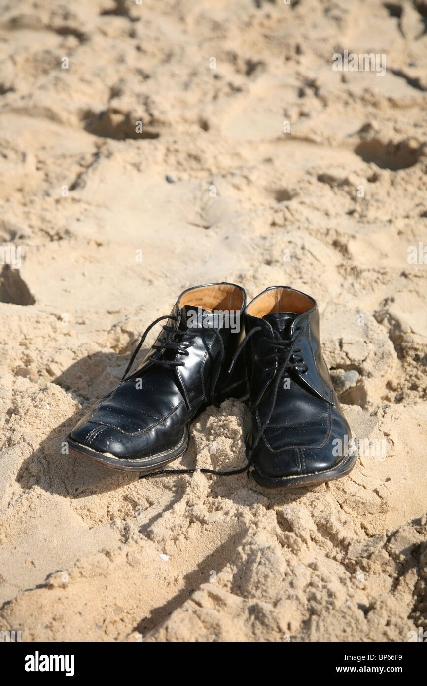 A pair of smart mens shoes on a sandy beach Stock Photo - Alamy