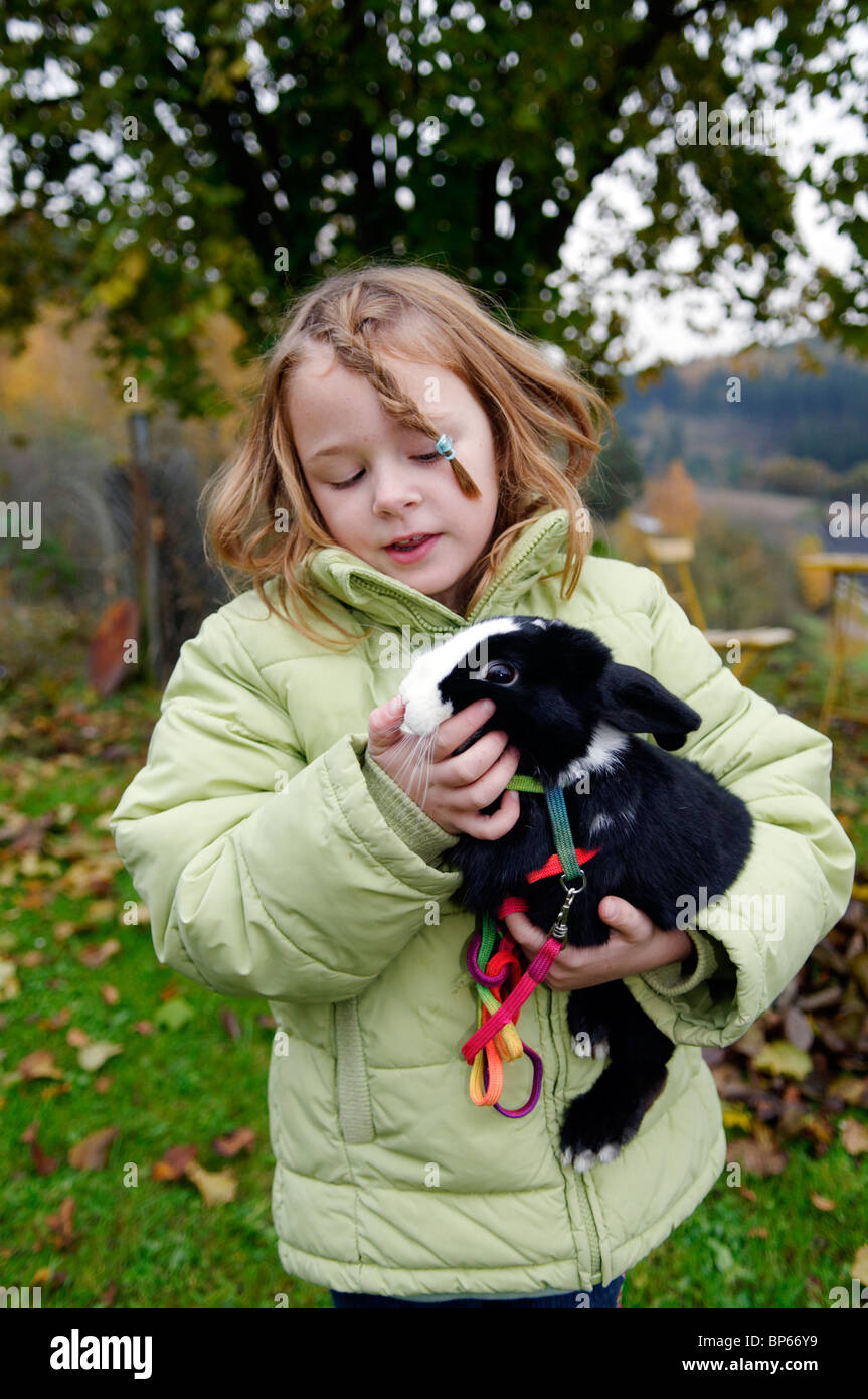 young girl playing with her pet rabbit Stock Photo - Alamy