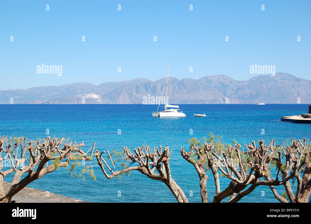 Luxury yacht, turquoise Aegean Sea and cut trees, Crete, Greece Stock ...
