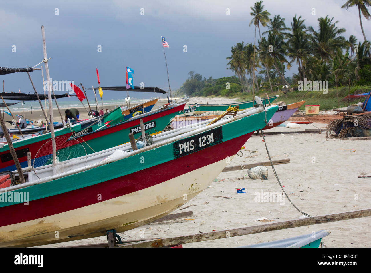Fishing boat on the beach at Beserah, Kuantan, as a storm front ...