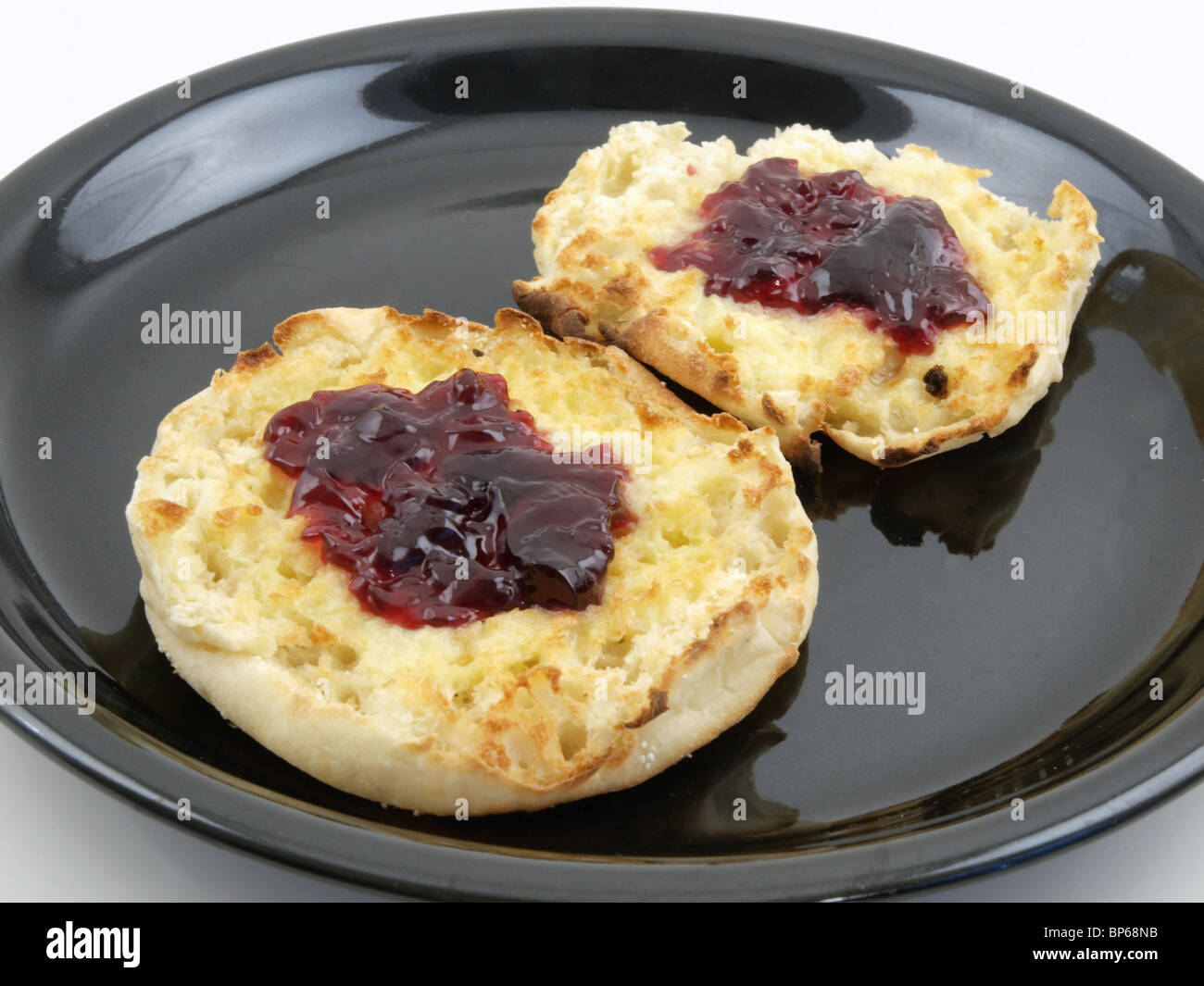 English Muffin with jam and butter, Toasted and ready to eat Stock ...