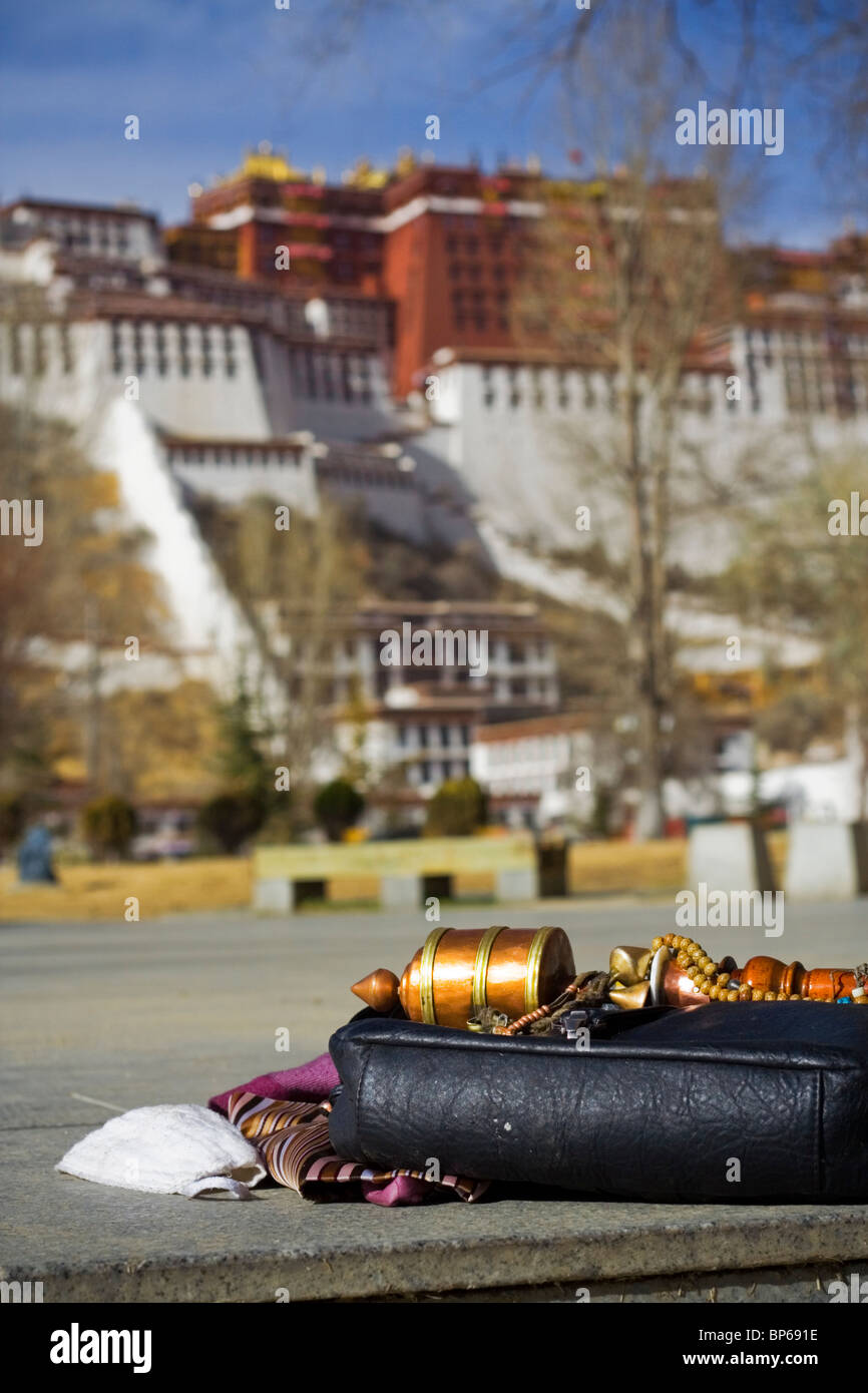 A pilgrims face mask and prayer wheel lie on the floor, in front of the ...
