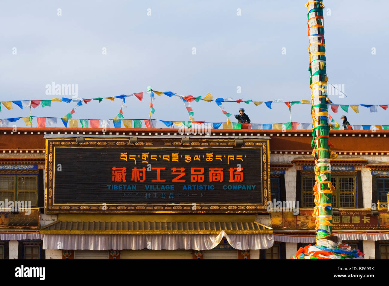 Chinese Police/army patrol the roofs of the shops surrounding Barkhor ...