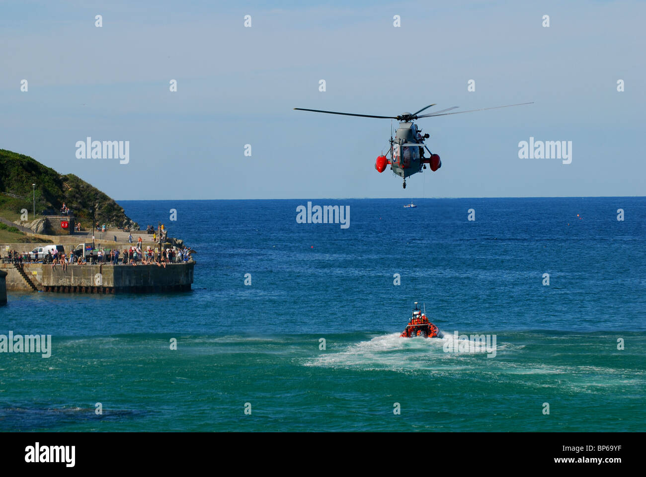 Royal Navy rescue helicopter with RNLI lifeboat in the water Stock ...