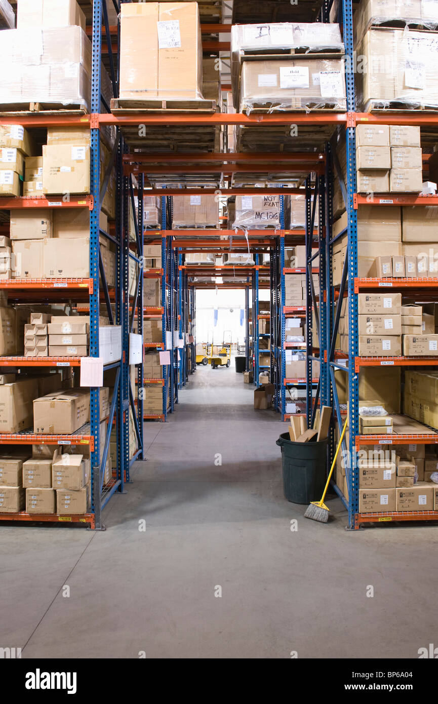 Cardboard boxes on shelves in distribution warehouse Stock Photo - Alamy