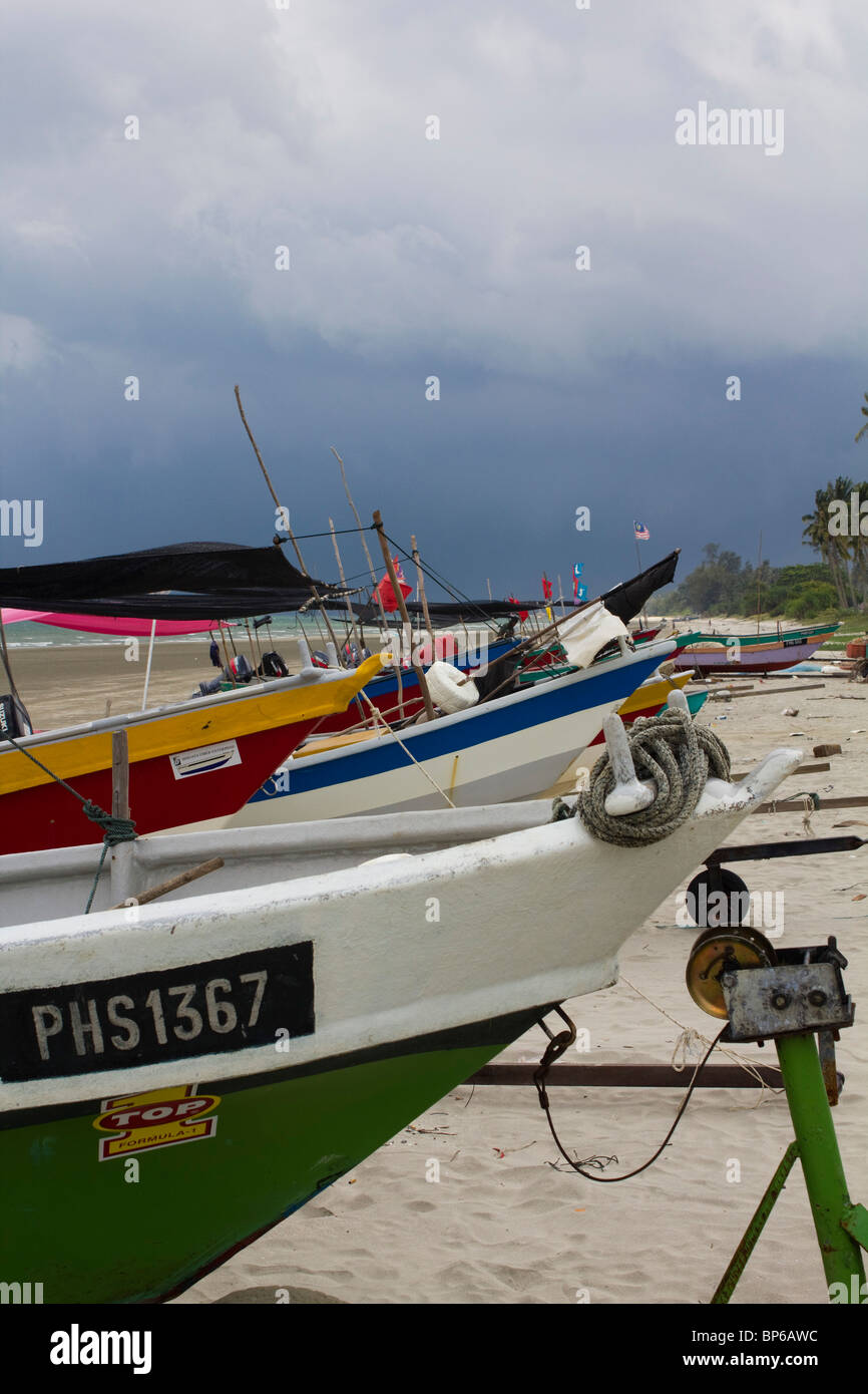 Fishing boat on the beach at Beserah, Kuantan, as a storm front ...