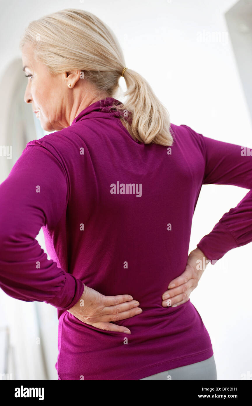 Woman standing with arms akimbo Stock Photo - Alamy
