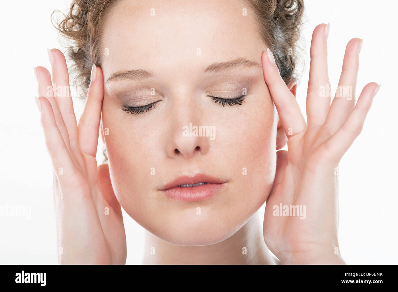 Close-up of a woman rubbing temples Stock Photo - Alamy