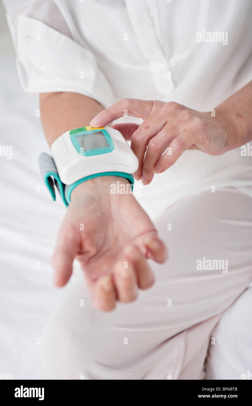 Woman checking her blood pressure Stock Photo - Alamy