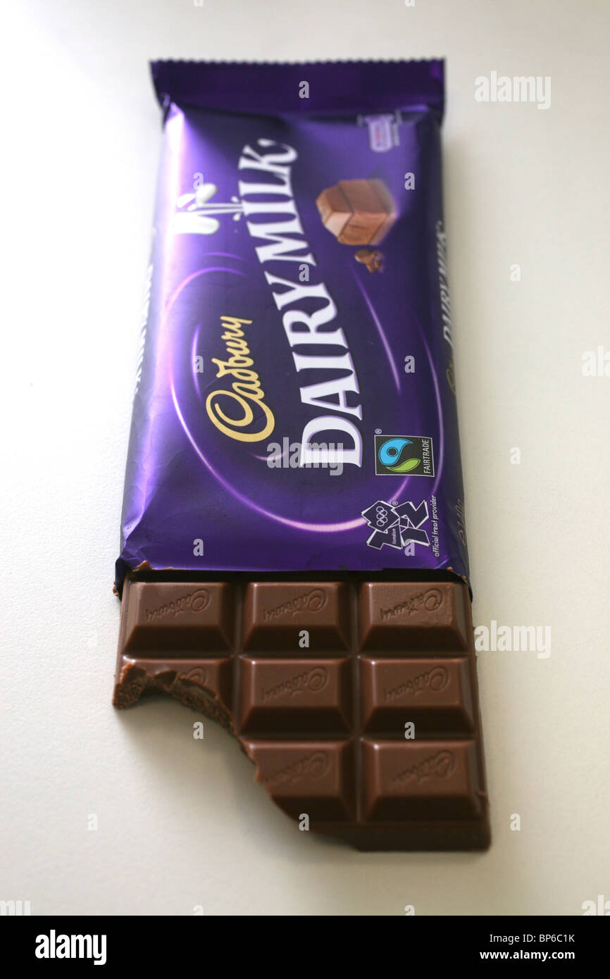 A bar of Cadbury Dairy Milk chocolate in it's wrapper with a bite taken ...