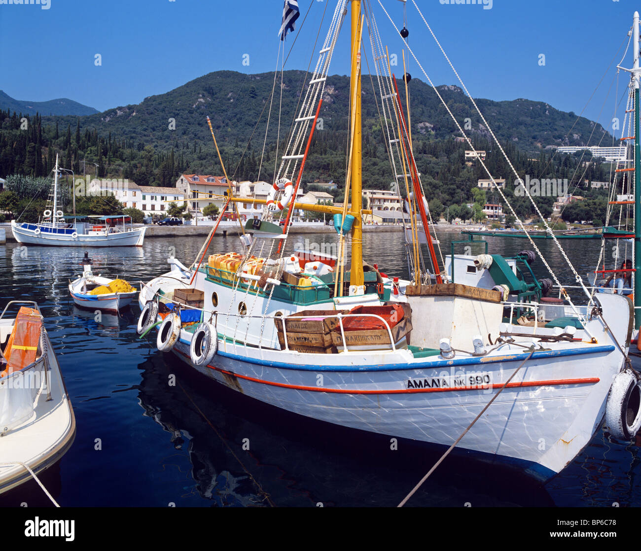 Corfu - Typical Greek fishing boat in Benitses harbour Stock Photo - Alamy