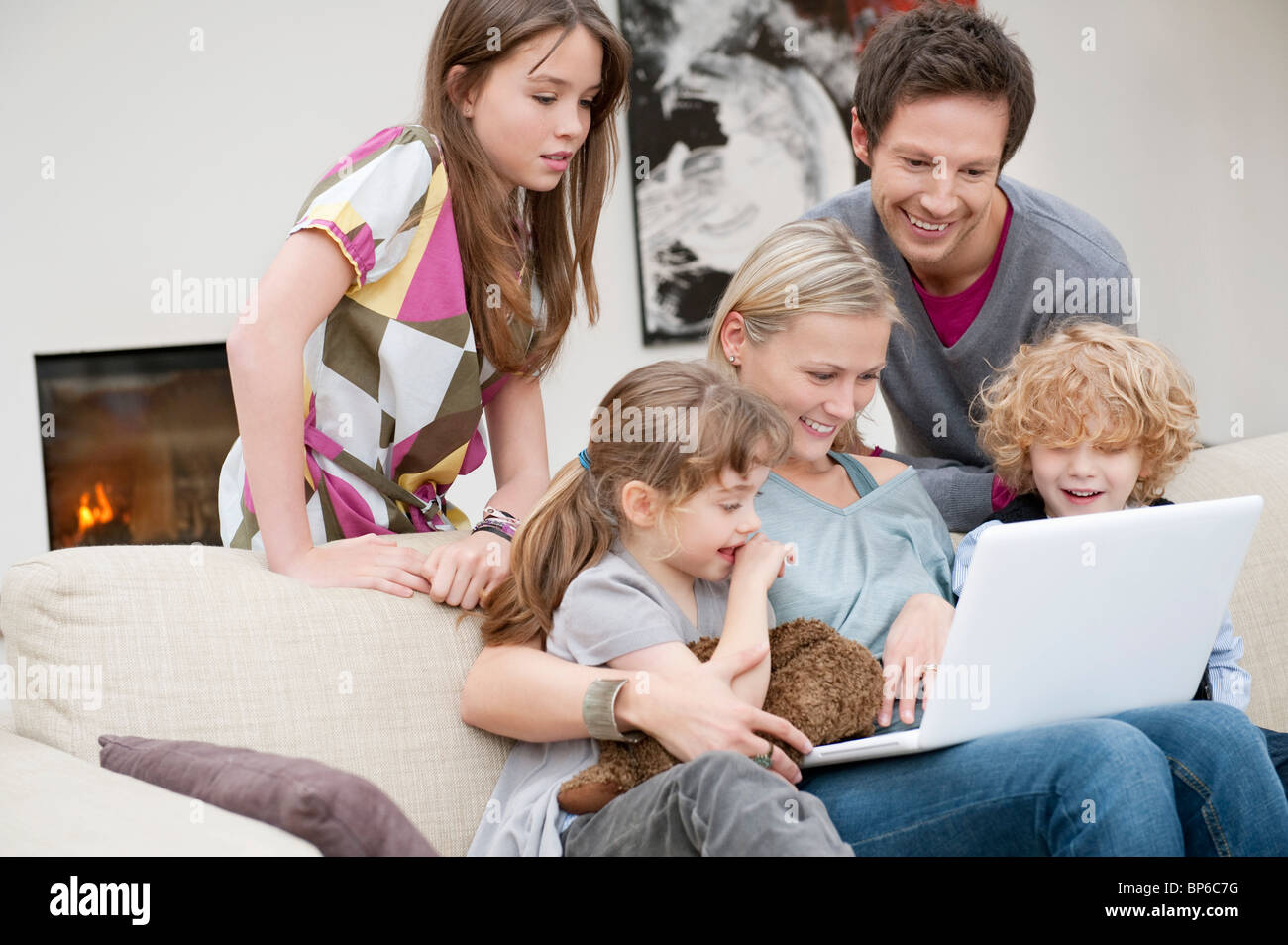 Family using a laptop Stock Photo - Alamy