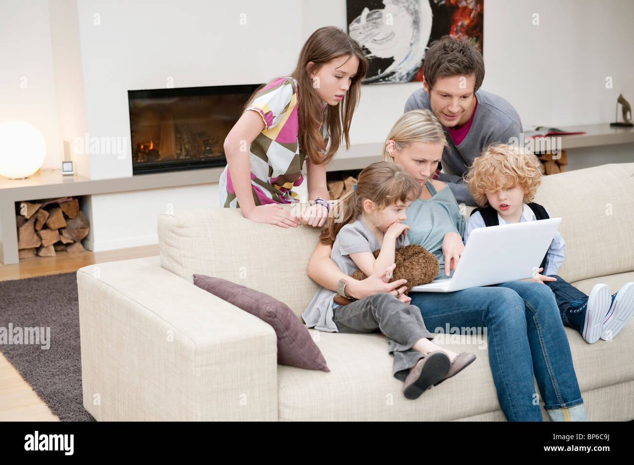 Family using a laptop Stock Photo - Alamy