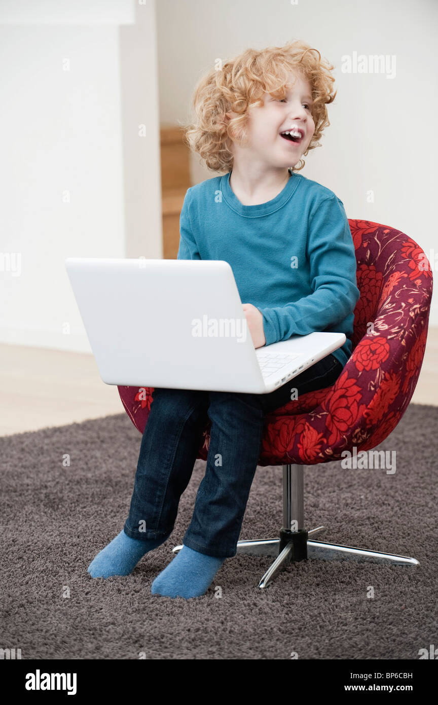 Boy using a laptop Stock Photo - Alamy