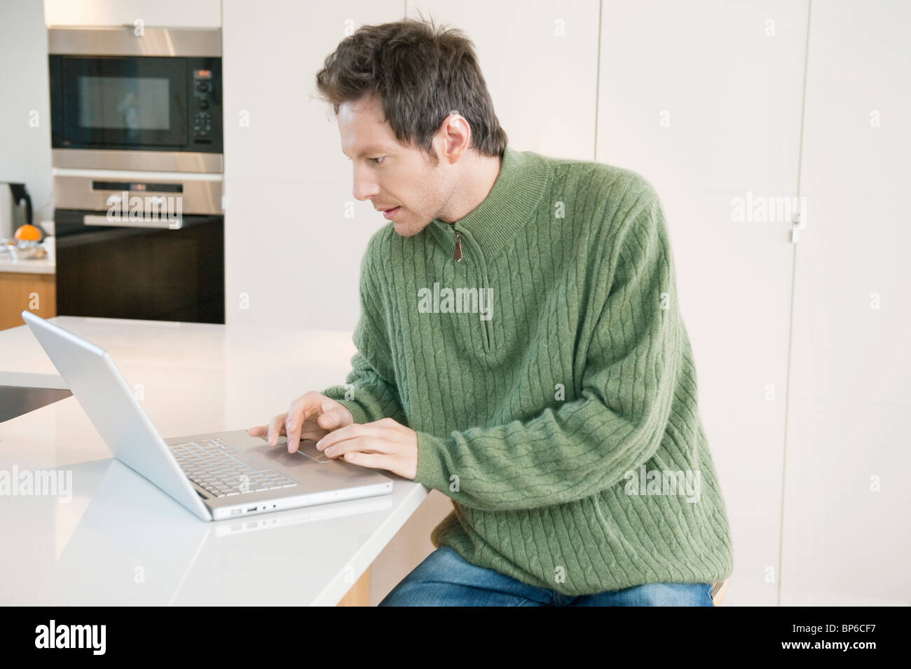 Man working on a laptop Stock Photo - Alamy