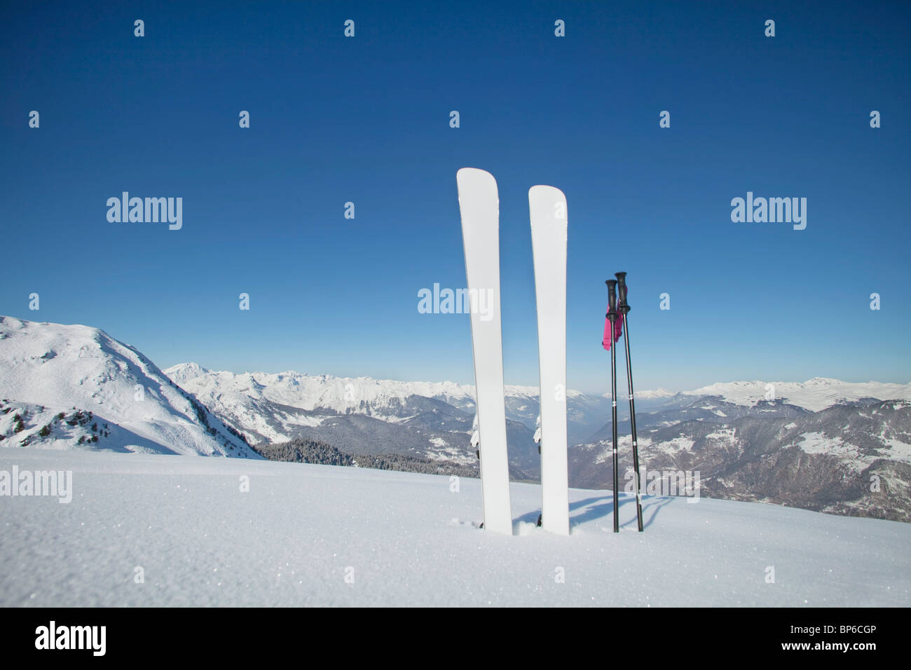 Skis and ski poles stuck in the snow Stock Photo - Alamy