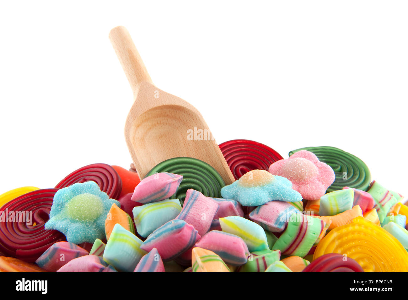 Many candy sweets with wooden spoon isolated over white Stock Photo - Alamy