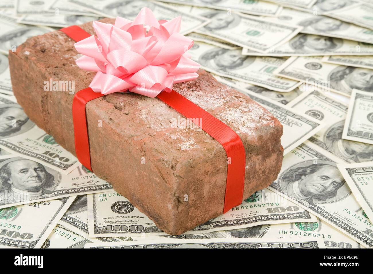 Red Brick Gift and dollars, Concept of joke, make fun of somebody, gift ...