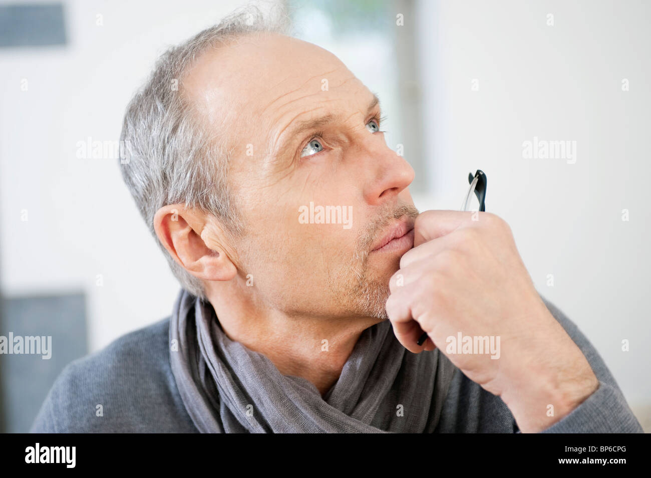 Close-up of a man thinking Stock Photo - Alamy