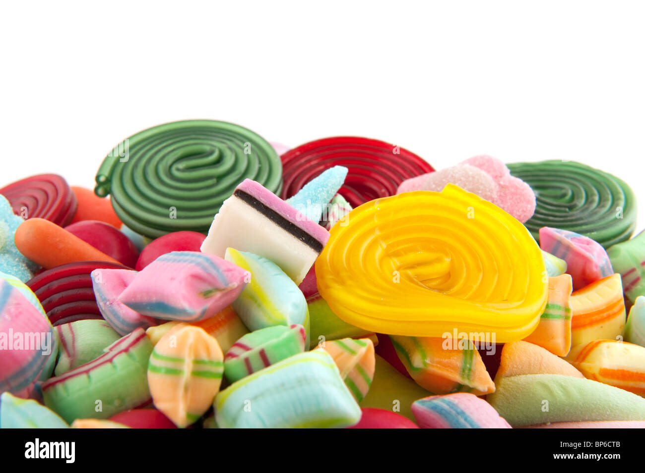 Many candy sweets with wooden spoon isolated over white Stock Photo - Alamy