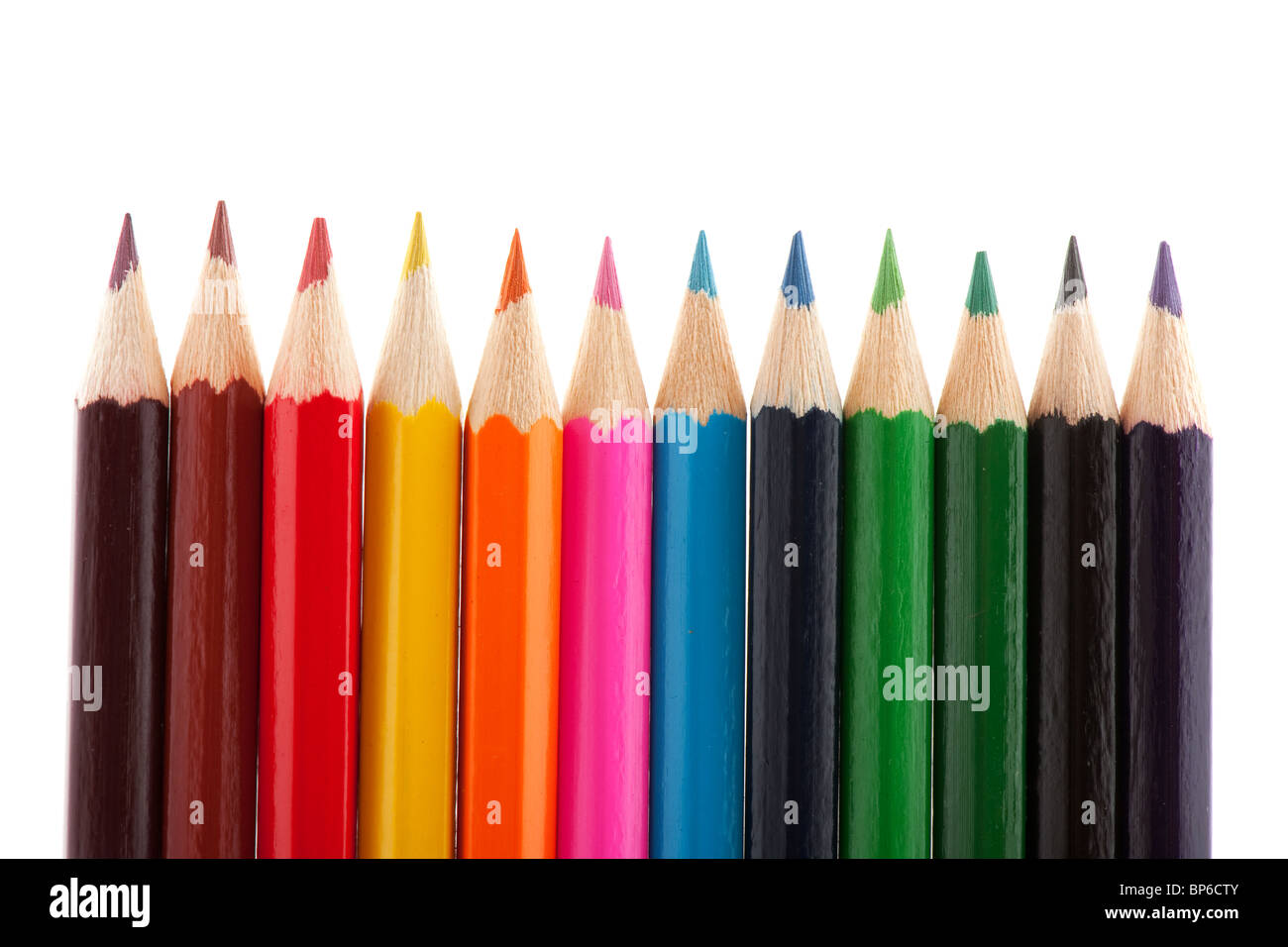 Row with color pencils on white background Stock Photo - Alamy
