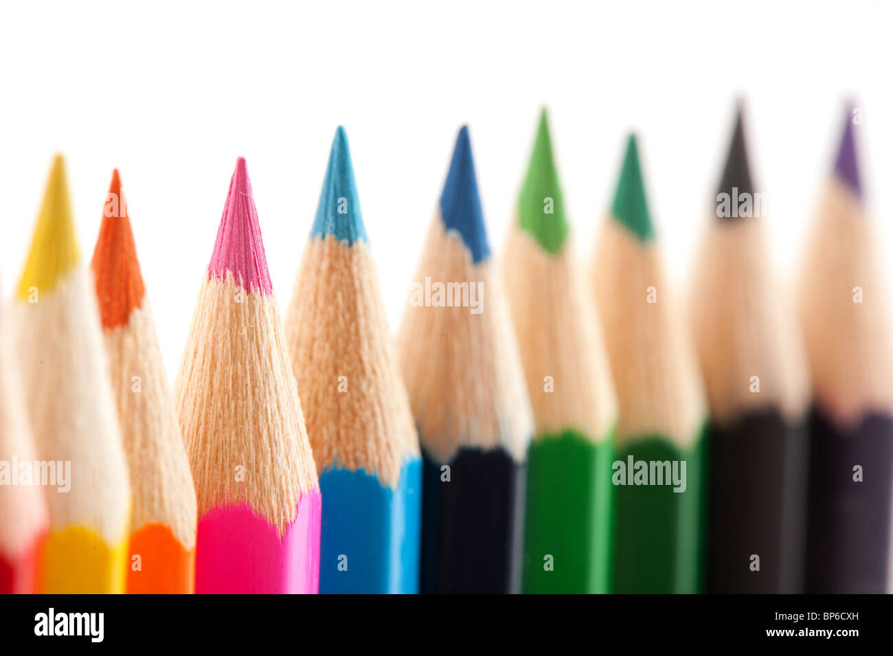 Row with color pencils on white background Stock Photo - Alamy