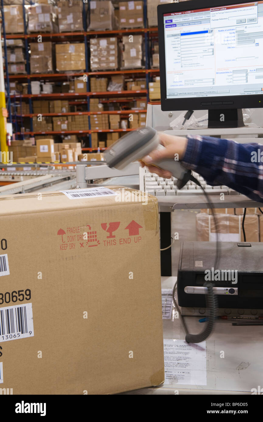 Man scanning bar code in distribution warehouse Stock Photo - Alamy