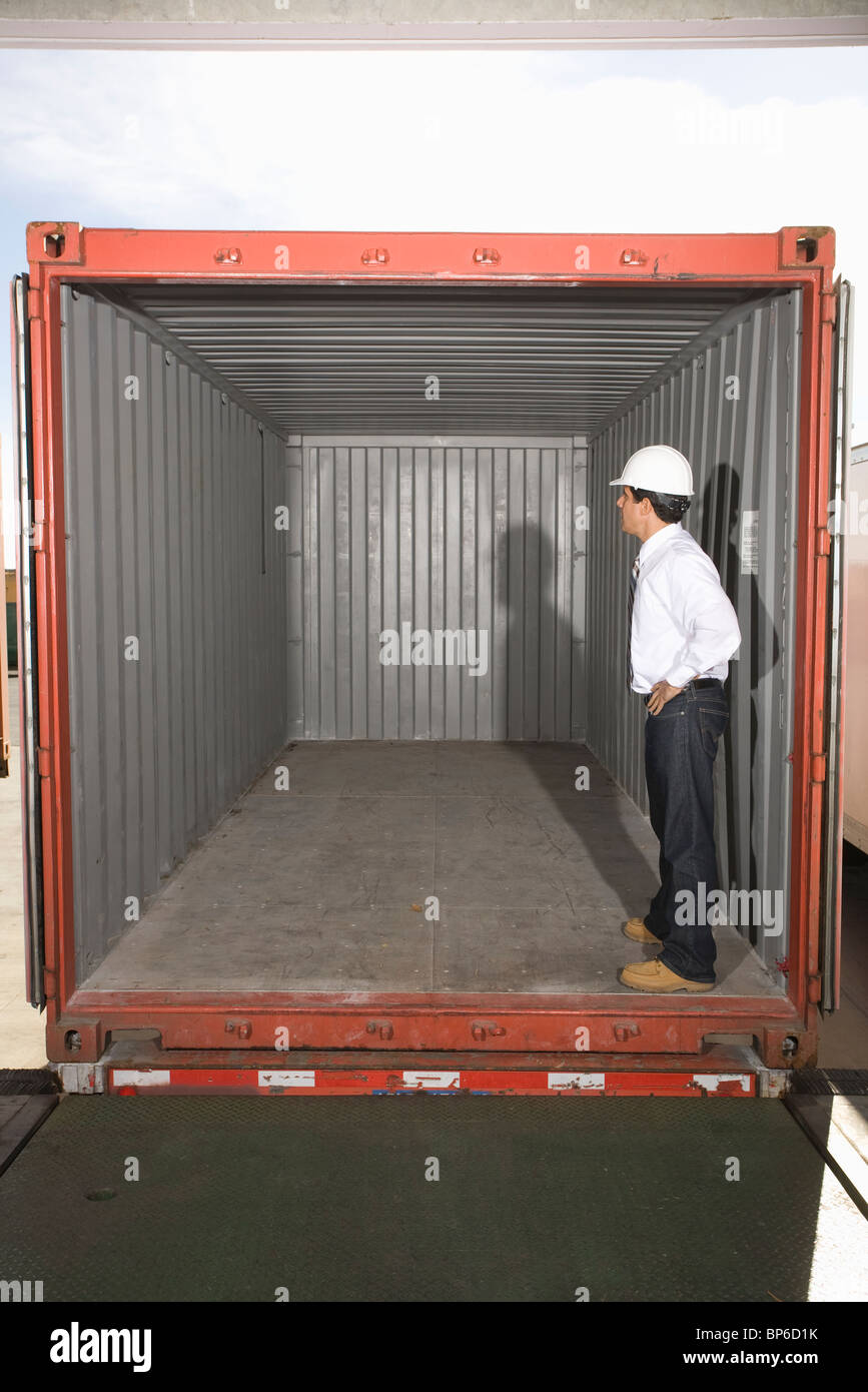 Man standing inside empty container Stock Photo - Alamy