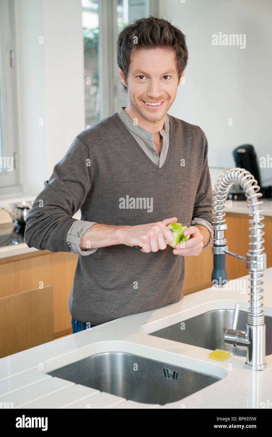 Portrait of a man working in the kitchen Stock Photo - Alamy